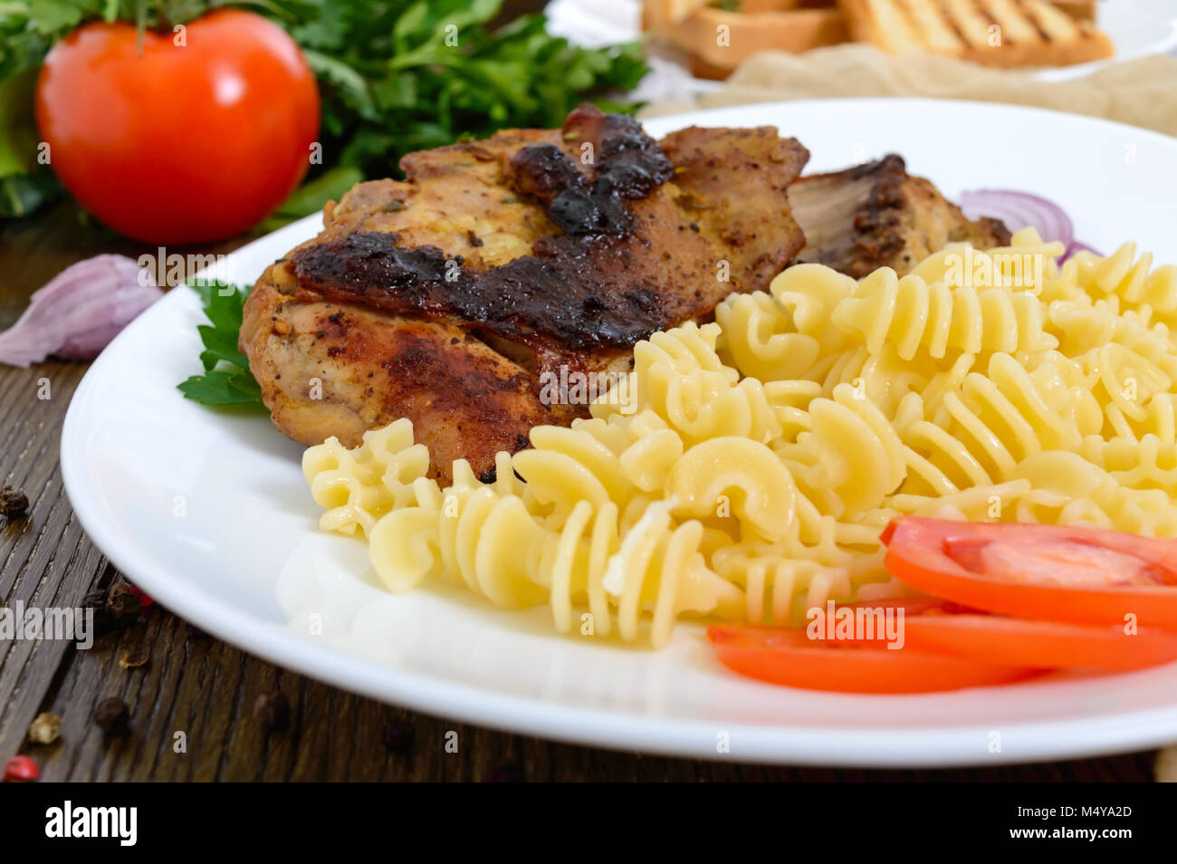 Pasta Radiatori and fried rabbit ribs Stock Photo - Alamy