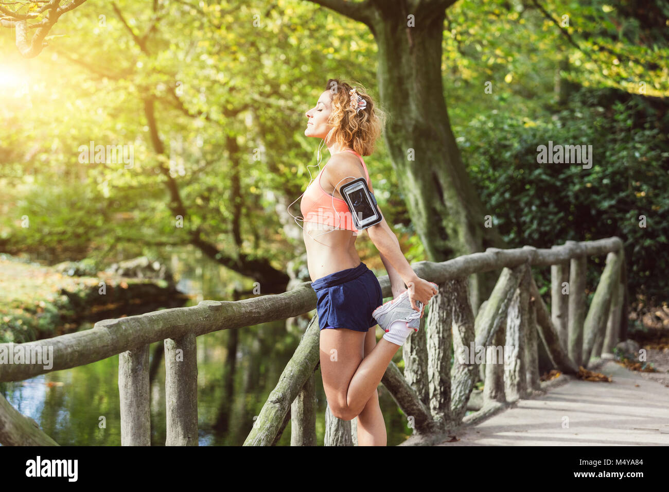 young fitness woman runner stretching legs before run Stock Photo - Alamy
