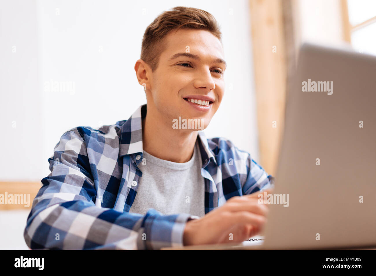 Happy boy working on his laptop Stock Photo - Alamy