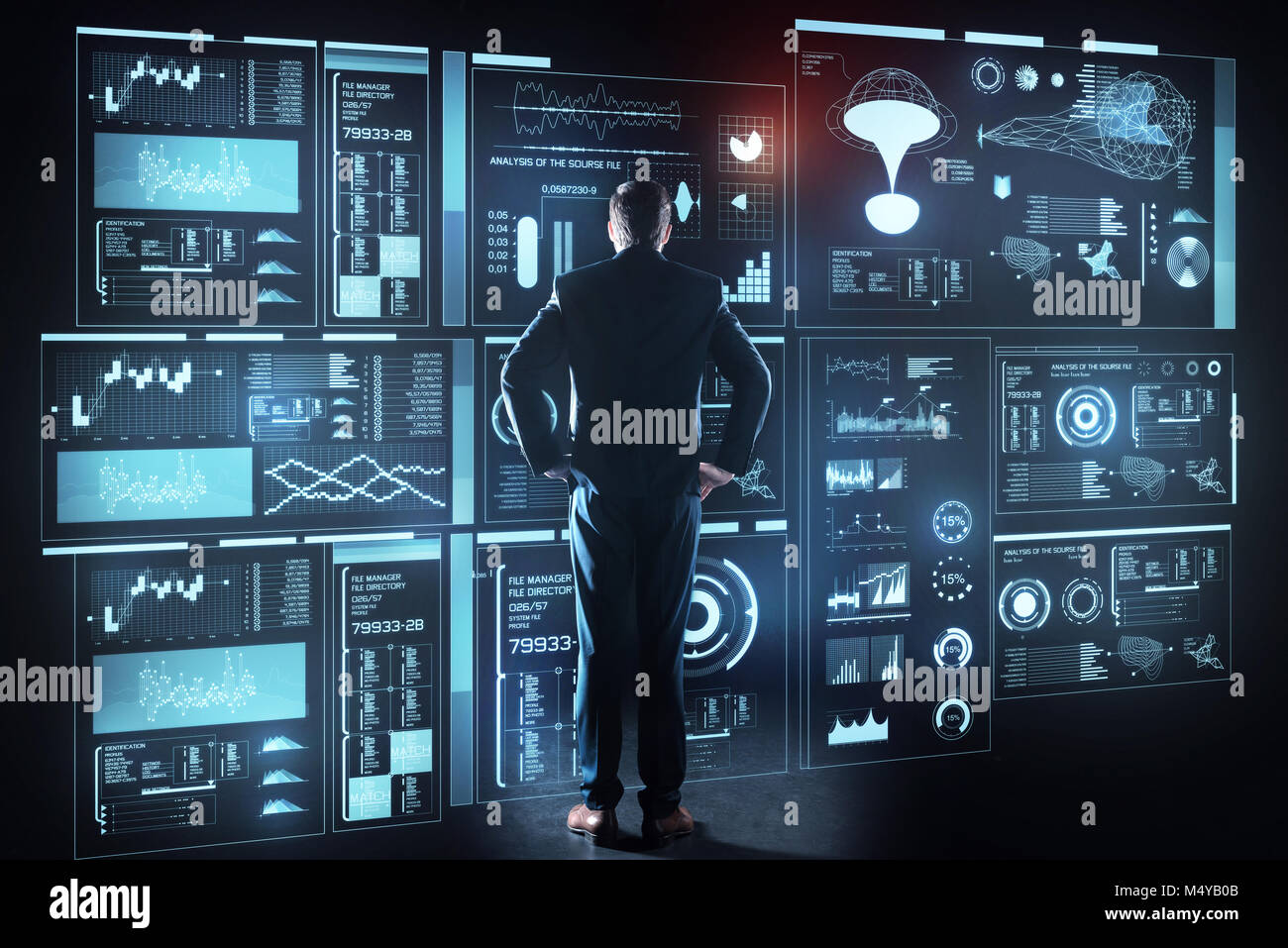 Young programmer standing with his hands on the hips and thinking Stock ...