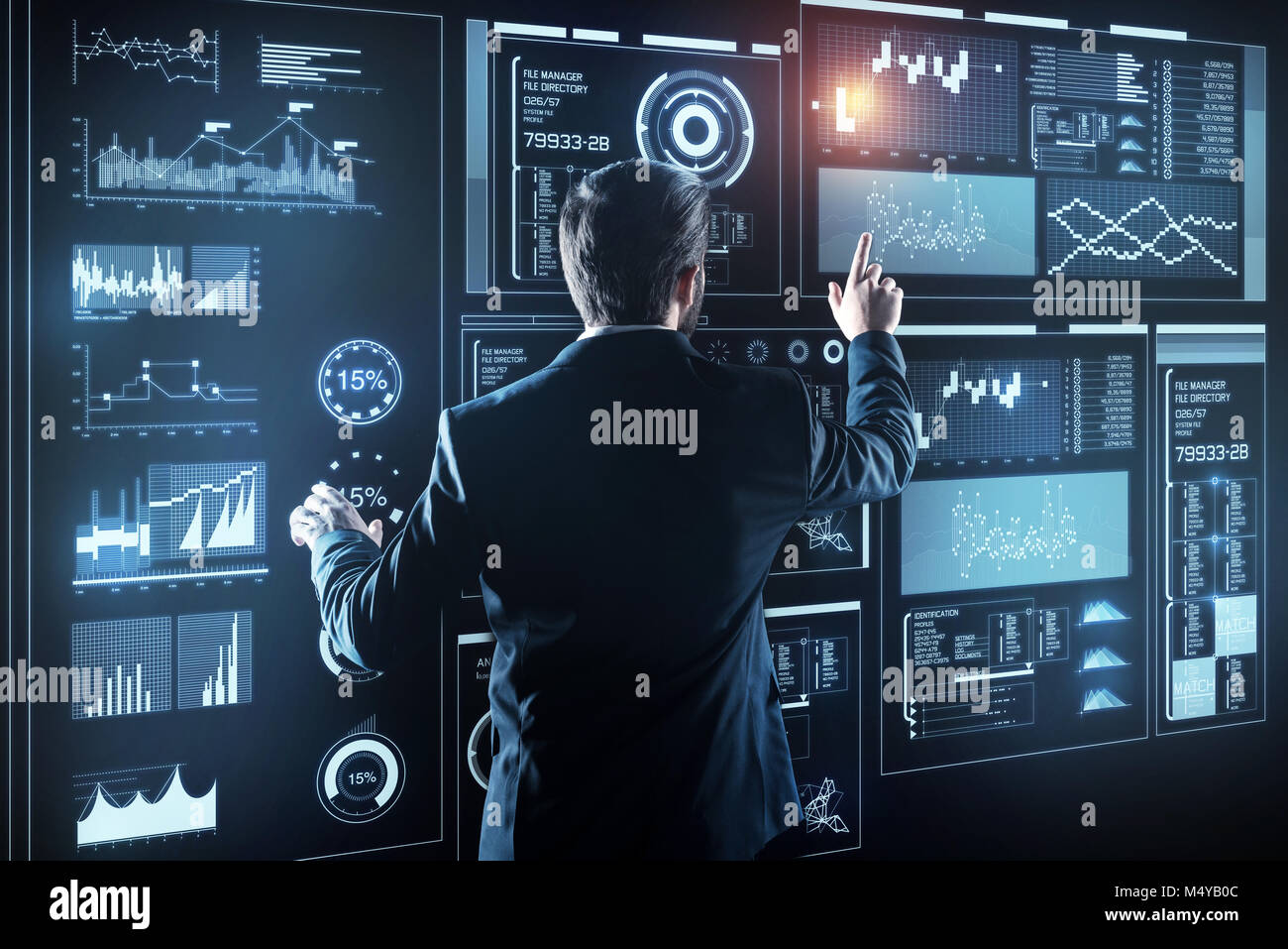 Careful programmer standing in front of a screen while working with information Stock Photo - Alamy
