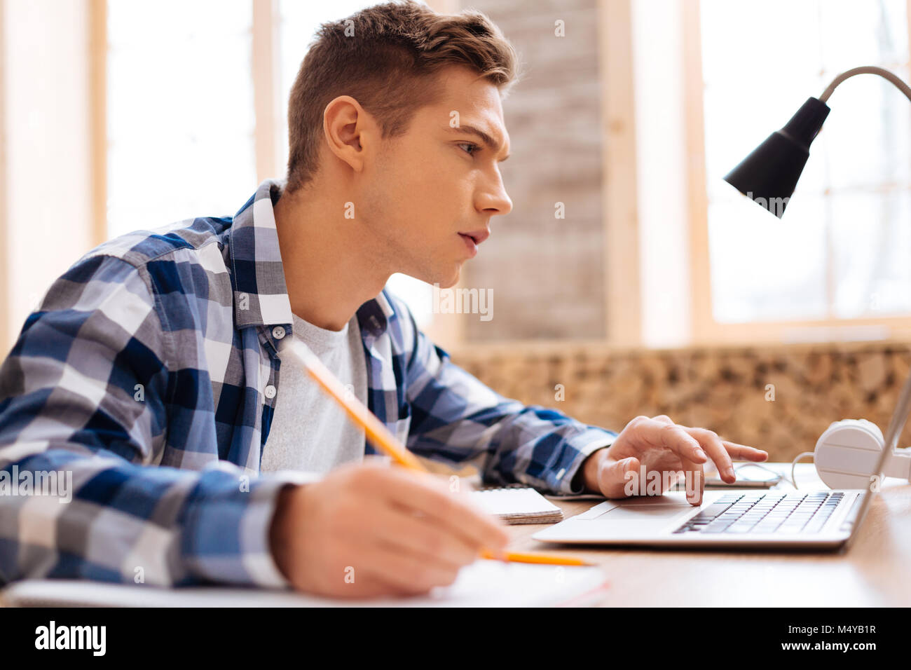 Concentrated boy learning his lessons at home Stock Photo - Alamy