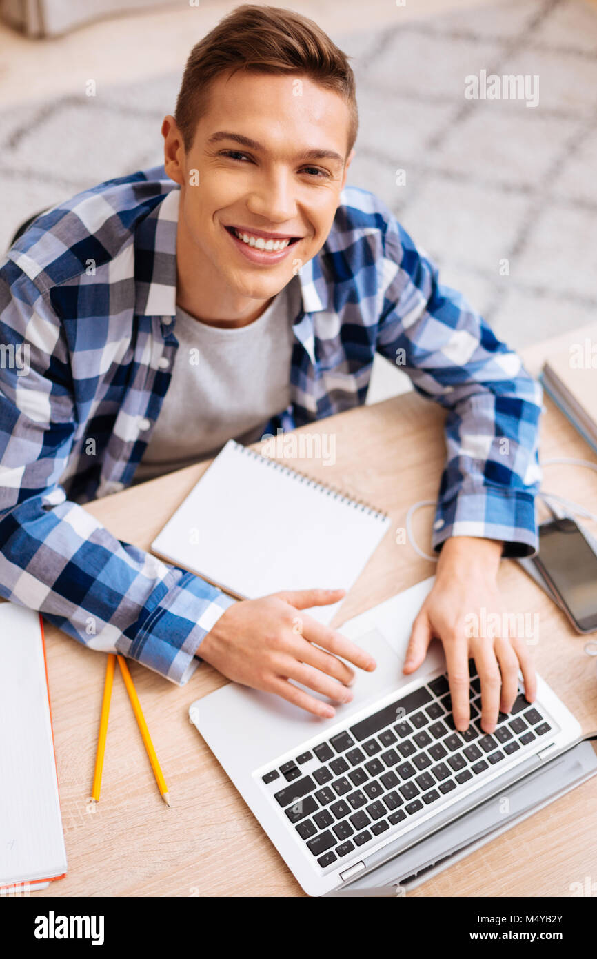 Cheerful schoolboy doing his homework Stock Photo - Alamy