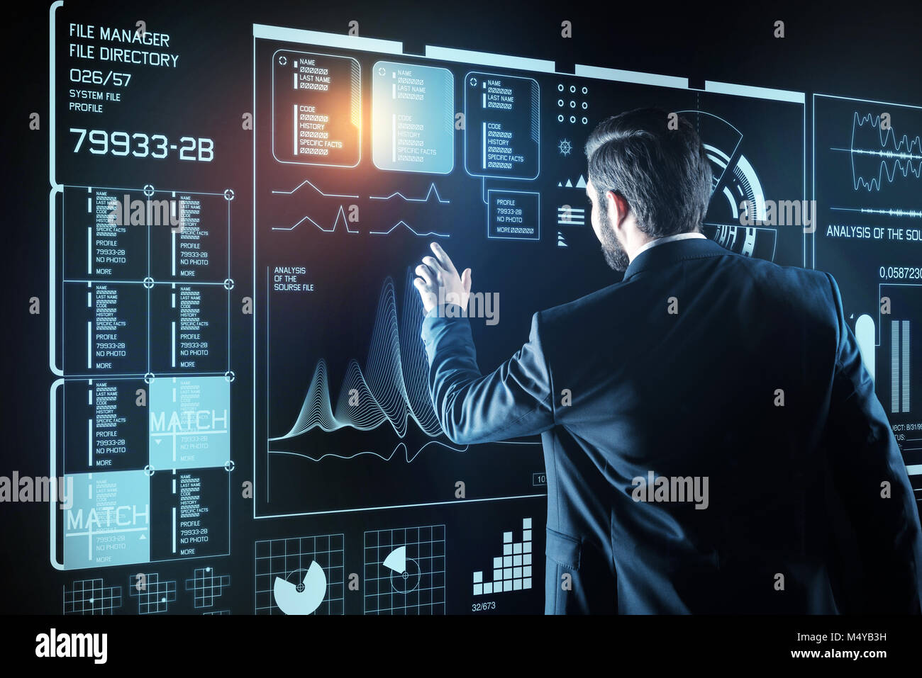 Attentive programmer touching the screen when working alone Stock Photo - Alamy