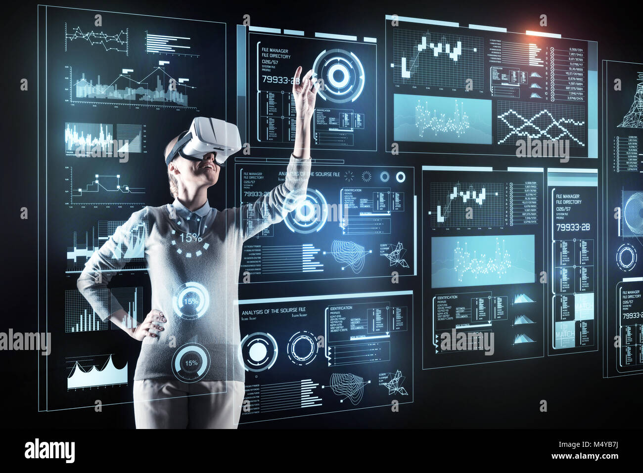 Positive person touching the screen while standing in front of it Stock ...