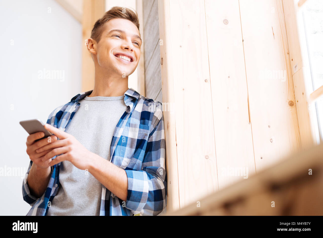 Delighted adolescent looking out the window Stock Photo - Alamy