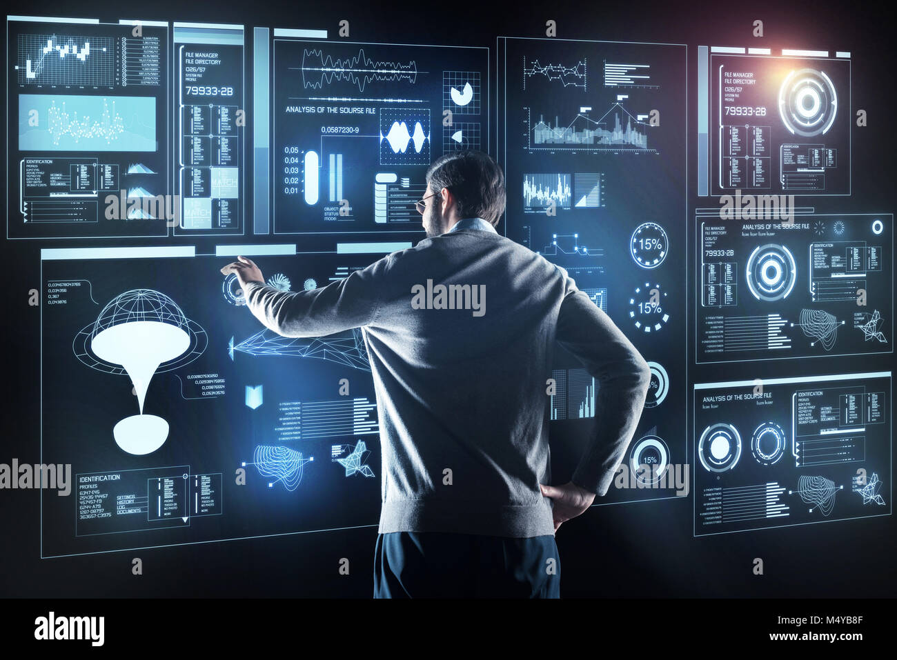 Professional programmer standing alone and looking at the screen Stock ...