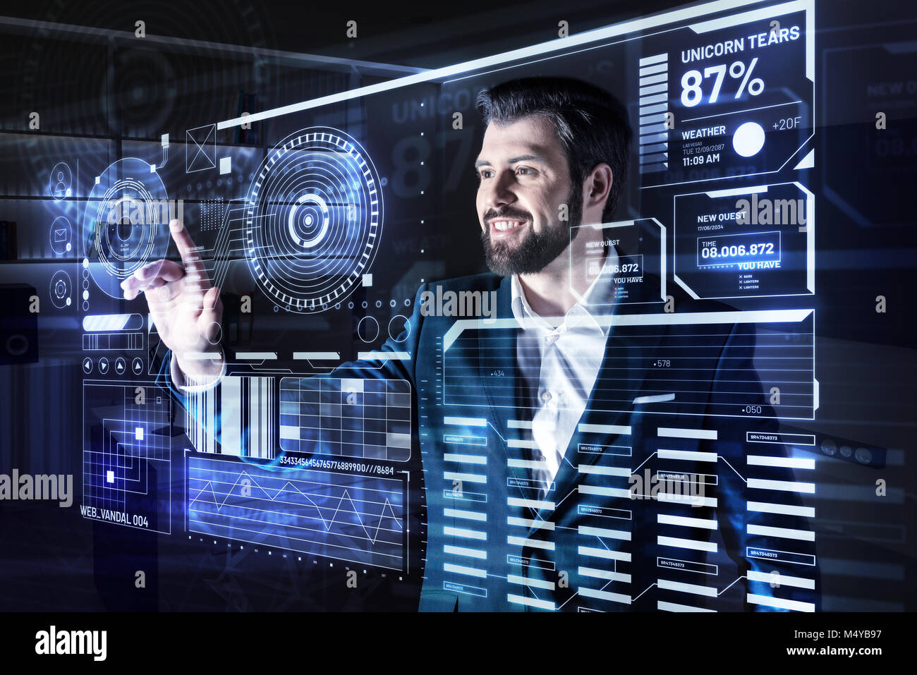 Positive employee smiling while working with convenient technologies ...