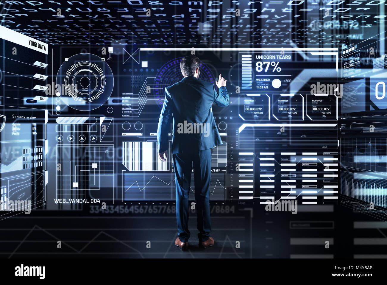Attentive programmer looking at the futuristic screen while touching it Stock Photo - Alamy