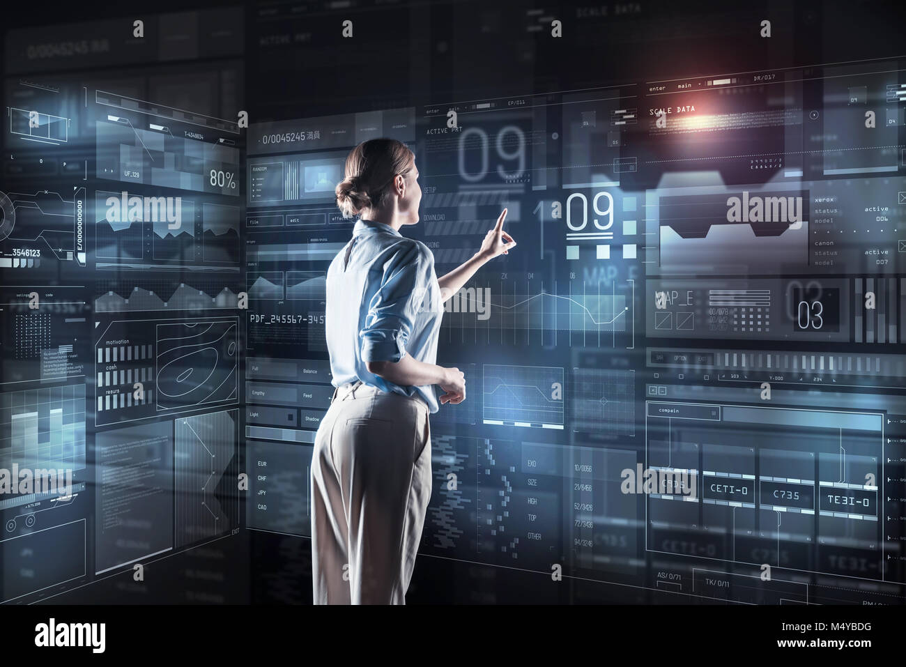 Calm programmer touching the screen while starting her working day ... Calm programmer touching the screen while starting her working day ...