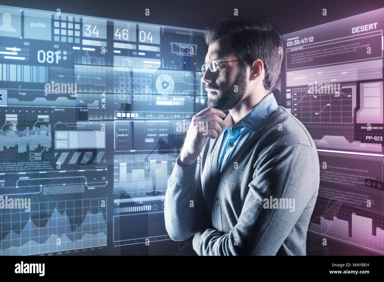 Concentrated man thoughtfully looking at the screen while working Stock Photo - Alamy