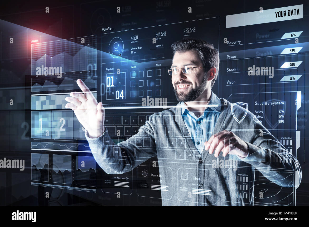 Positive programmer smiling while noticing important information Stock Photo - Alamy