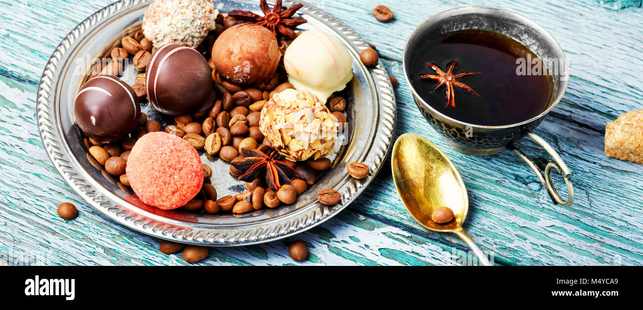 Delicious chocolate candies and fragrant black coffee Stock Photo - Alamy