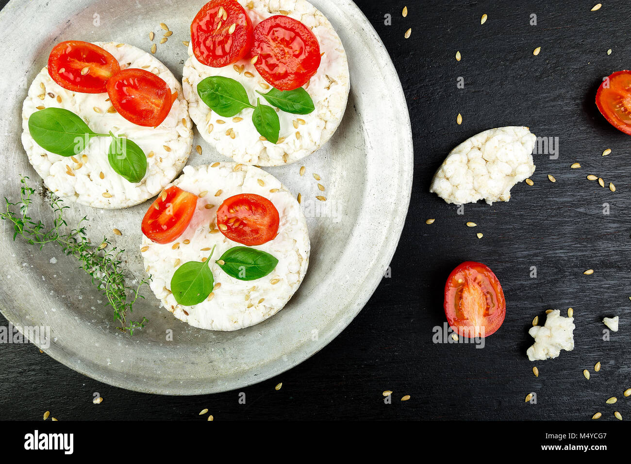 Healthy Rice Cakes with cherry tomatoes, cheese feta, basil and sesame ...