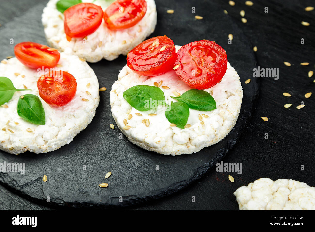 Healthy Rice Cakes with cherry tomatoes, cheese feta, basil and sesame ...
