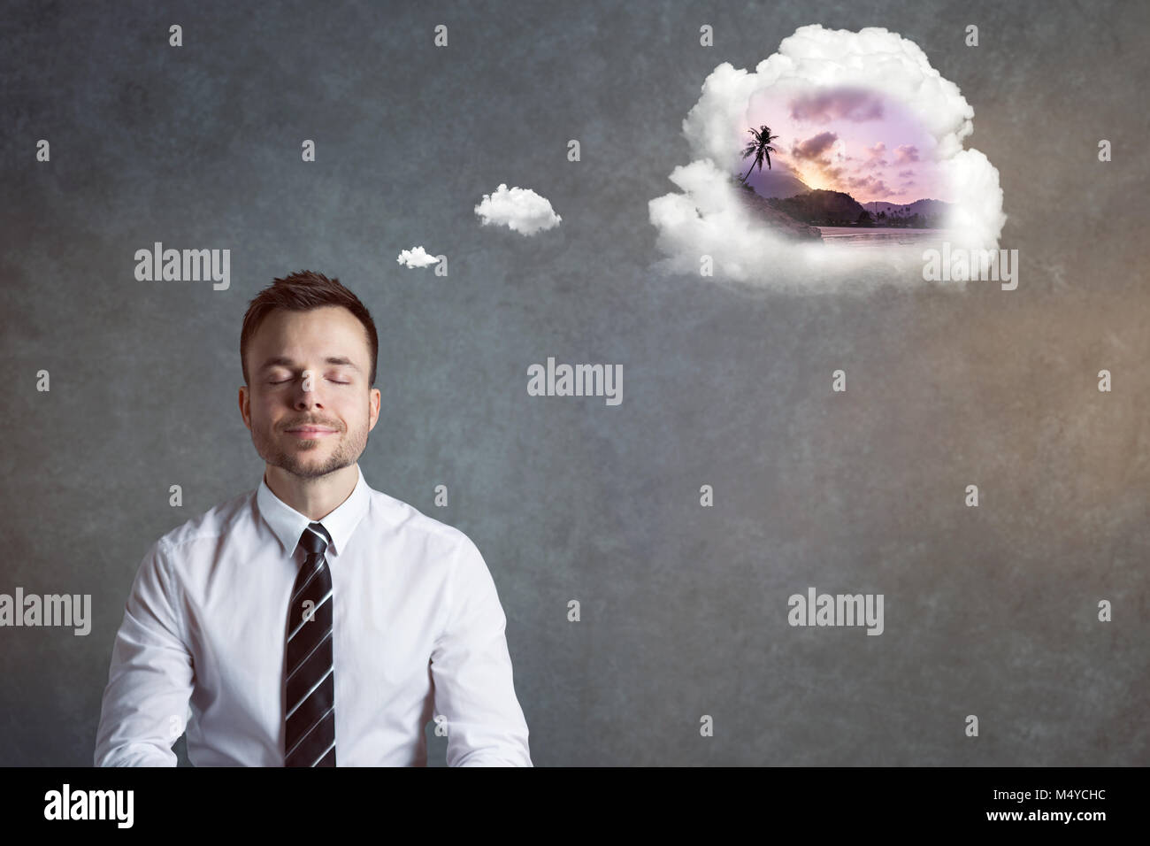 Smiling man thinking about holidays Stock Photo - Alamy