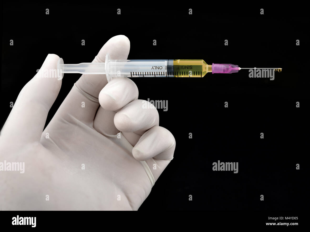 syringe in hand of doctor ready to injection to sick people in hospital ...