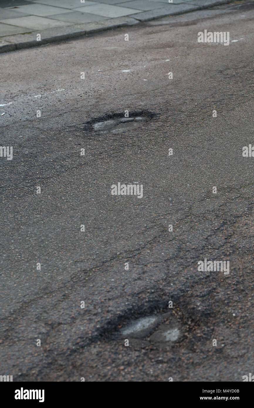 Potholes on roads in north London. Councils accused of putting lives at ...