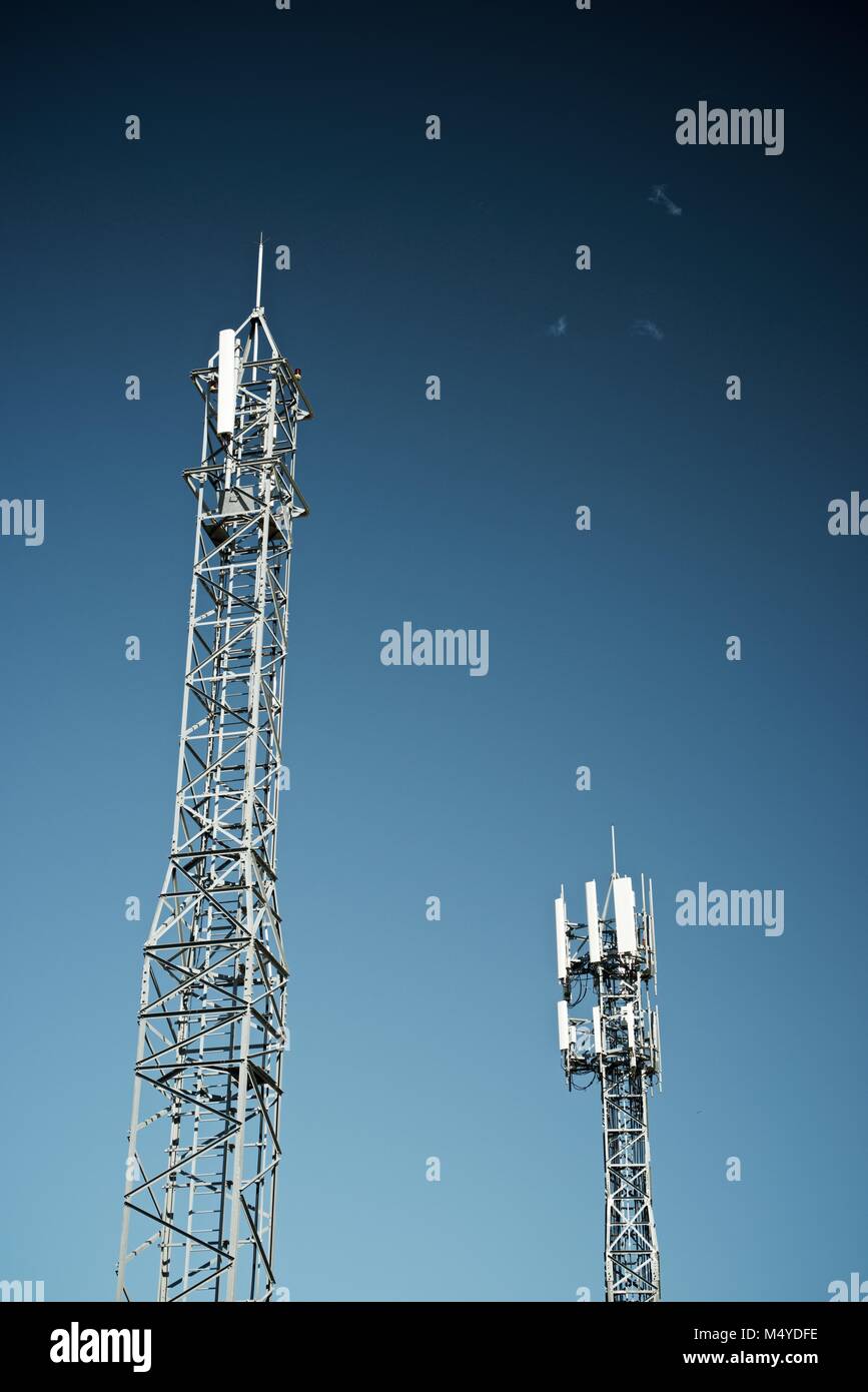 Telecommunications towers with clear blue sky Stock Photo - Alamy