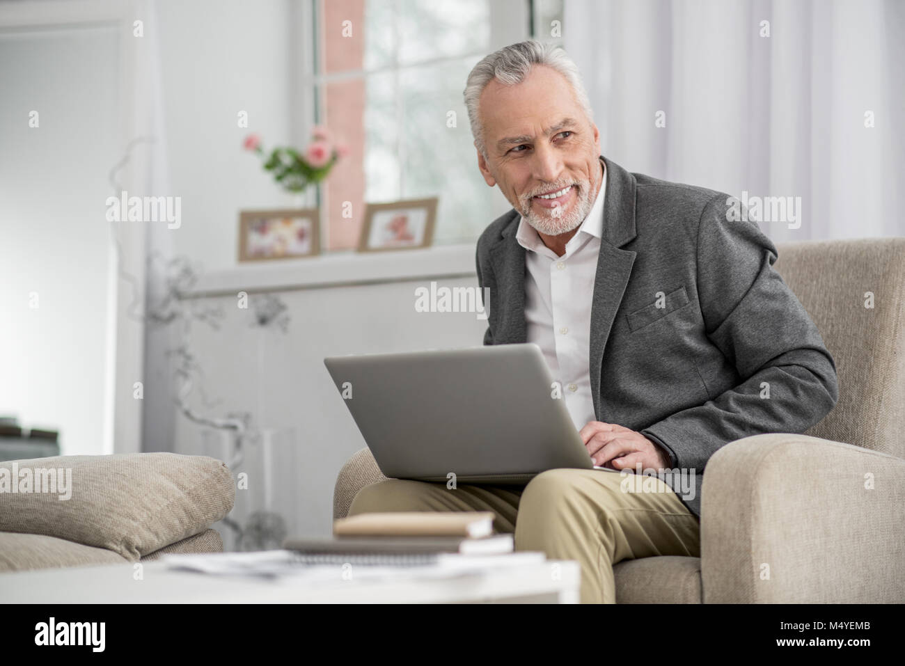Creative mature worker completing task Stock Photo - Alamy
