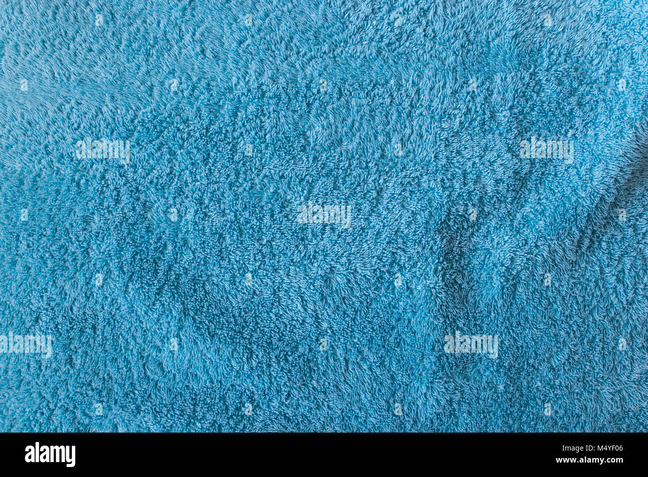 Close-up of soft turquoise towel texture background viewed from above ...