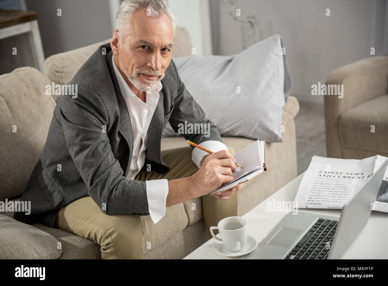 Competent businessman making important notes Stock Photo - Alamy