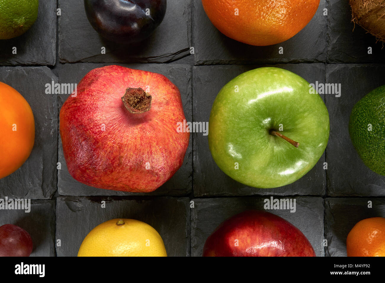 A variety of colorful fruits on black squares made of shale stone Stock ...