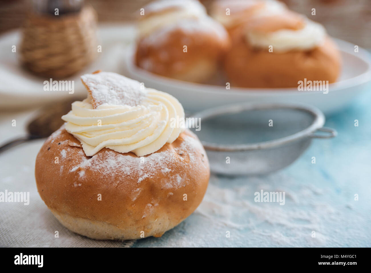 Semla swedish cream bun on light blue background Stock Photo - Alamy