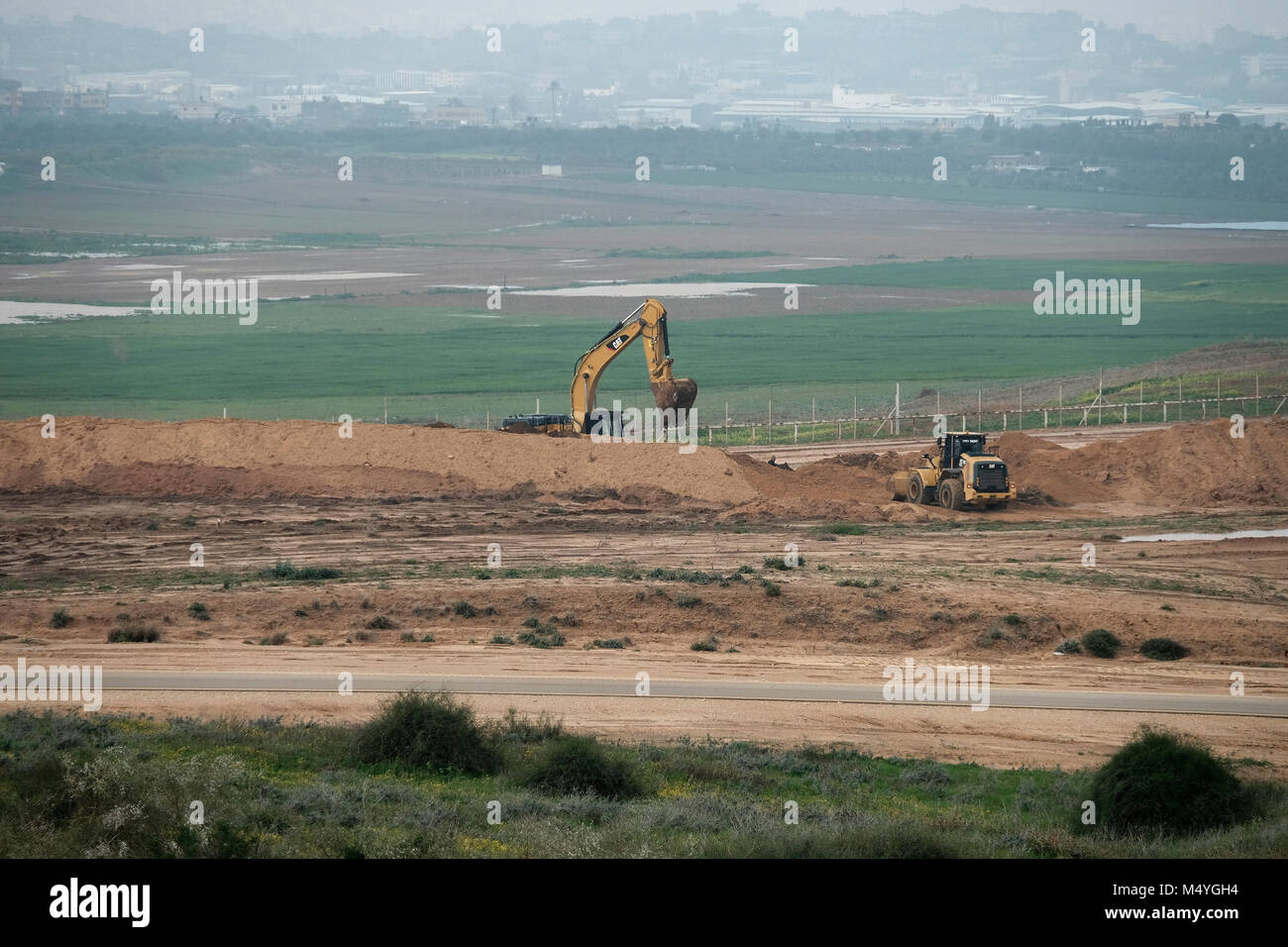Israeli bulldozer digs during construction of a new subterranean ...