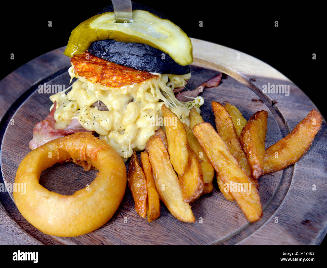 Homemade burger set serve on wooden plate photo with flash lighting ...