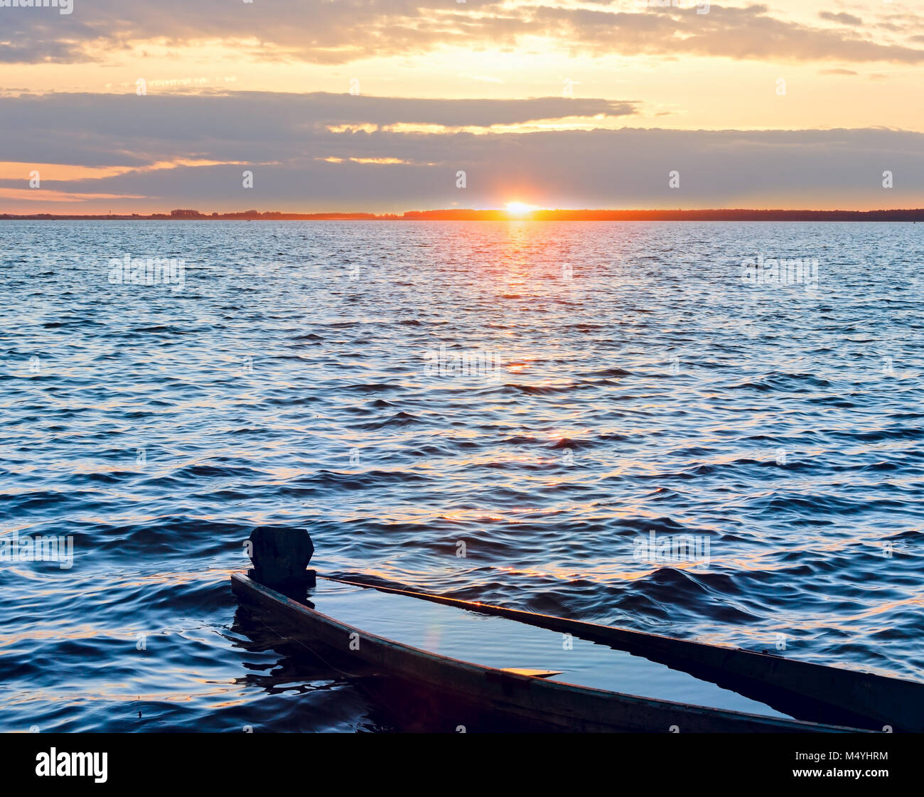 Sunset and drowned boat on summer lake bank Stock Photo - Alamy