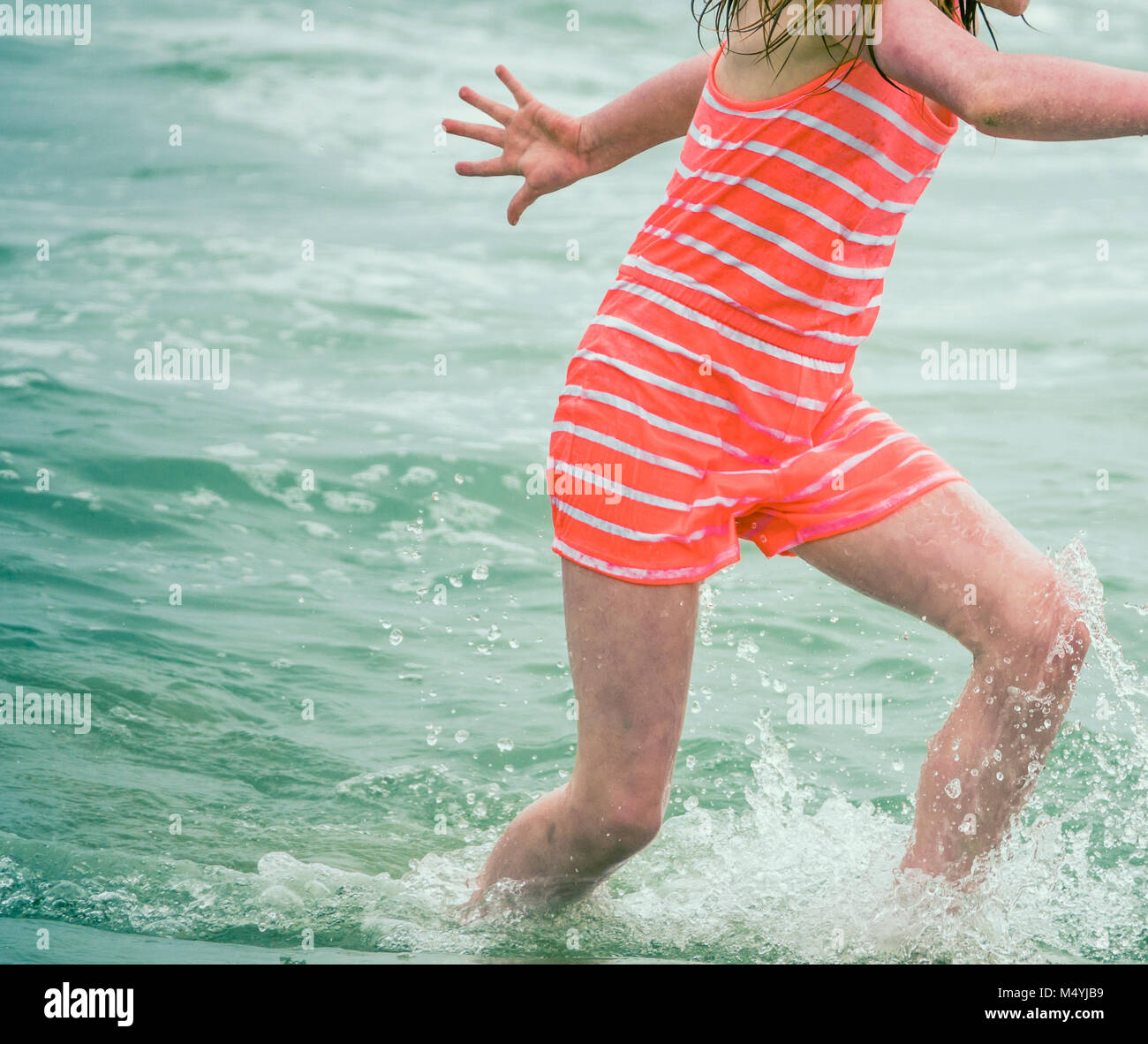 Children playing in waves hi-res stock photography and images - Alamy