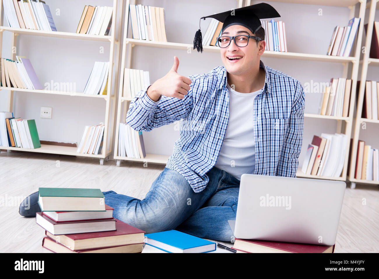 Young student studying with books Stock Photo - Alamy