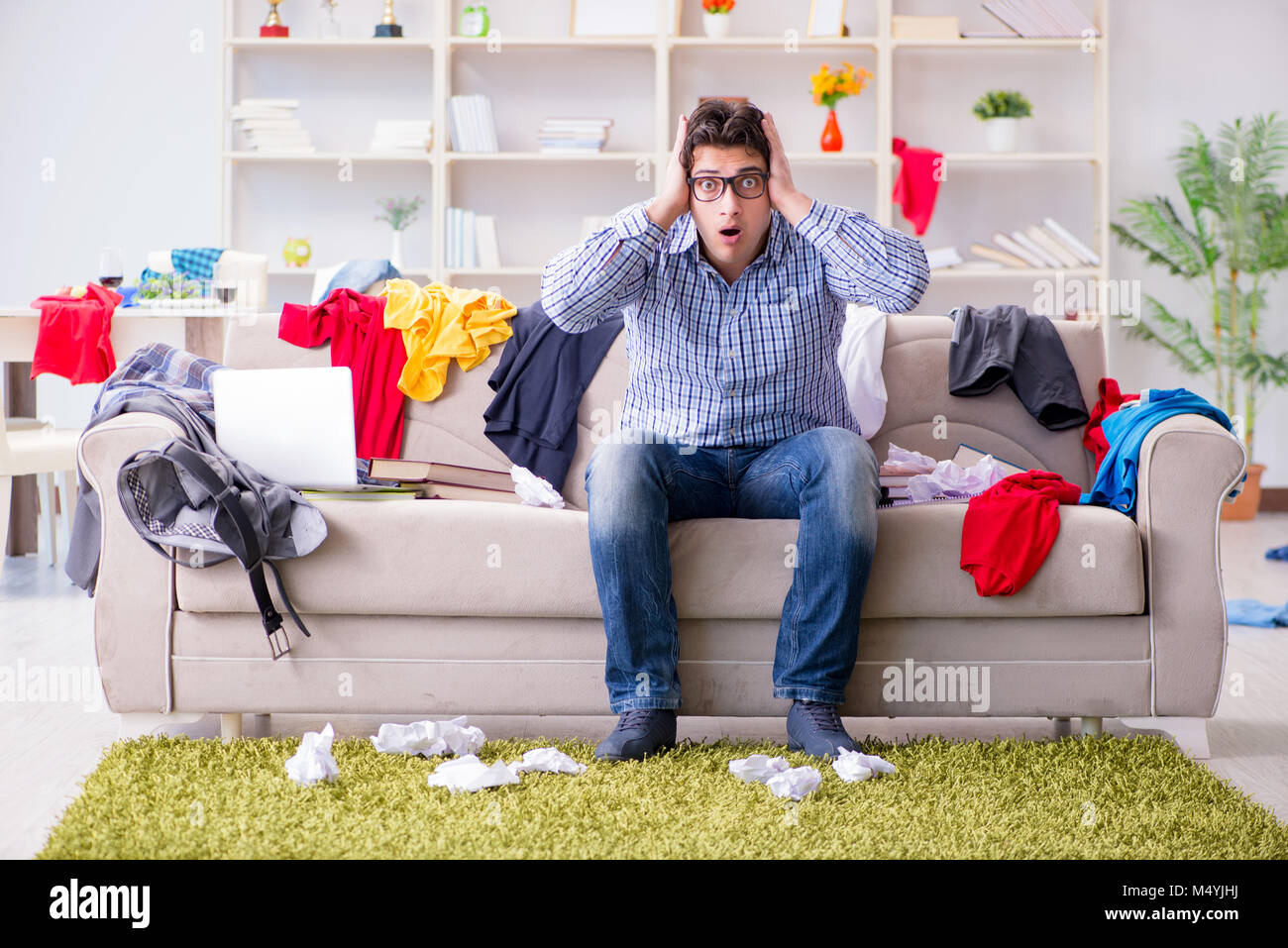 Young man working studying in messy room Stock Photo - Alamy