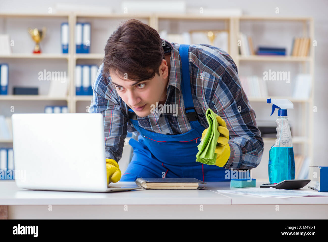 Hacker under cleaner cover stealing personal data Stock Photo - Alamy