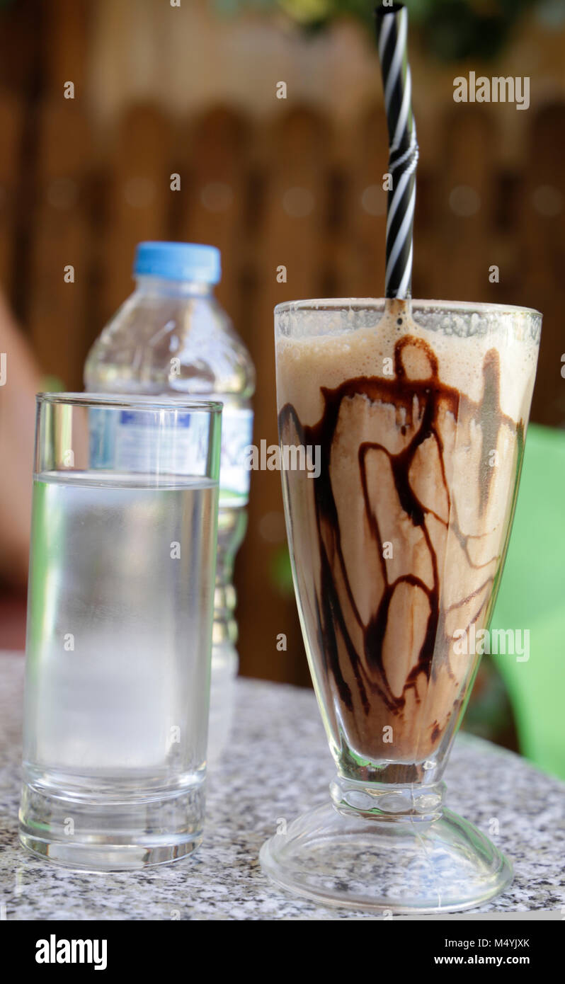 A chocolate milkshake and a bottle of water Stock Photo - Alamy