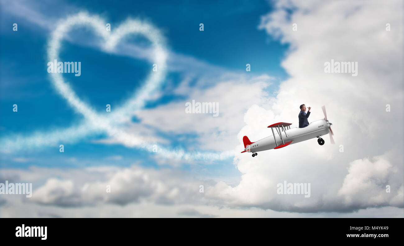 Man flying airplane and making heart shape Stock Photo - Alamy