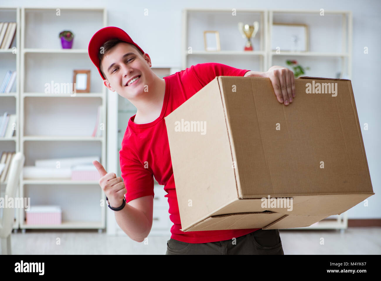 Post man delivering a parcel package Stock Photo - Alamy