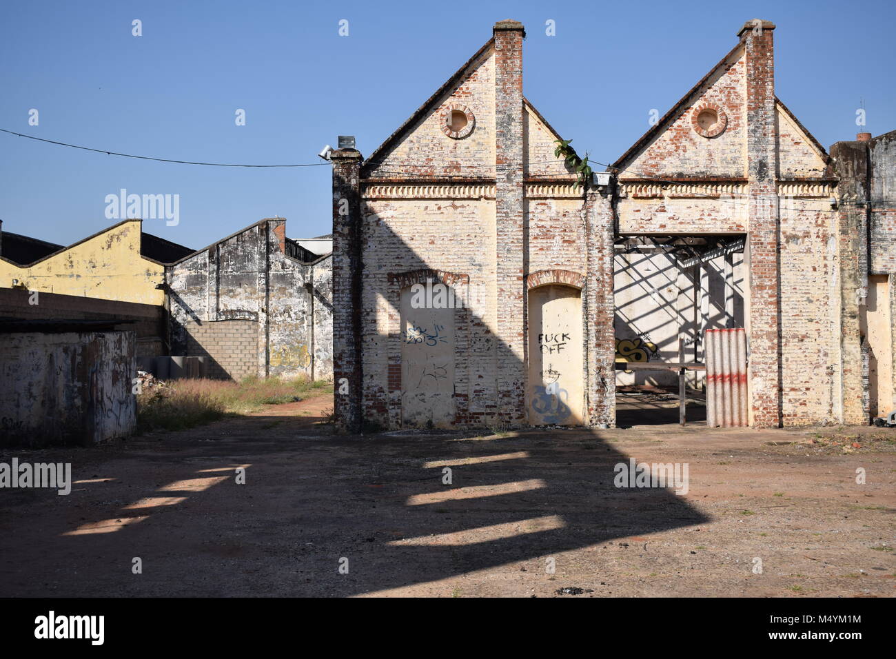 Facade of industrial shed of 19th century in ruins Stock Photo - Alamy
