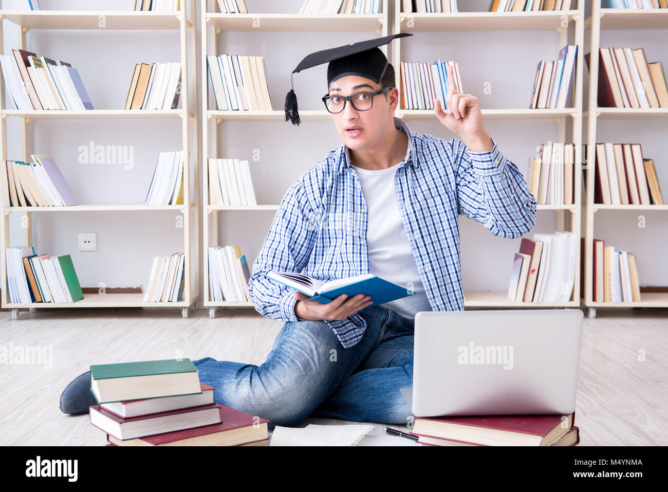 Young student studying with books Stock Photo - Alamy