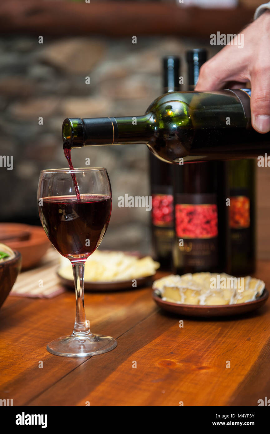 Pouring red wine Stock Photo - Alamy