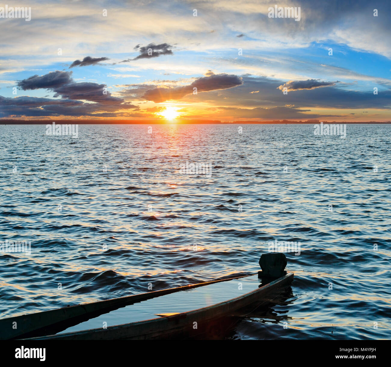 Sunset and drowned boat on summer lake bank Stock Photo - Alamy