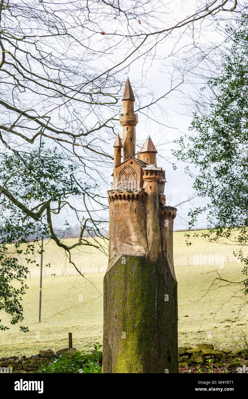 Carving of a castle made into a bird box on the stump of a dead tree ...