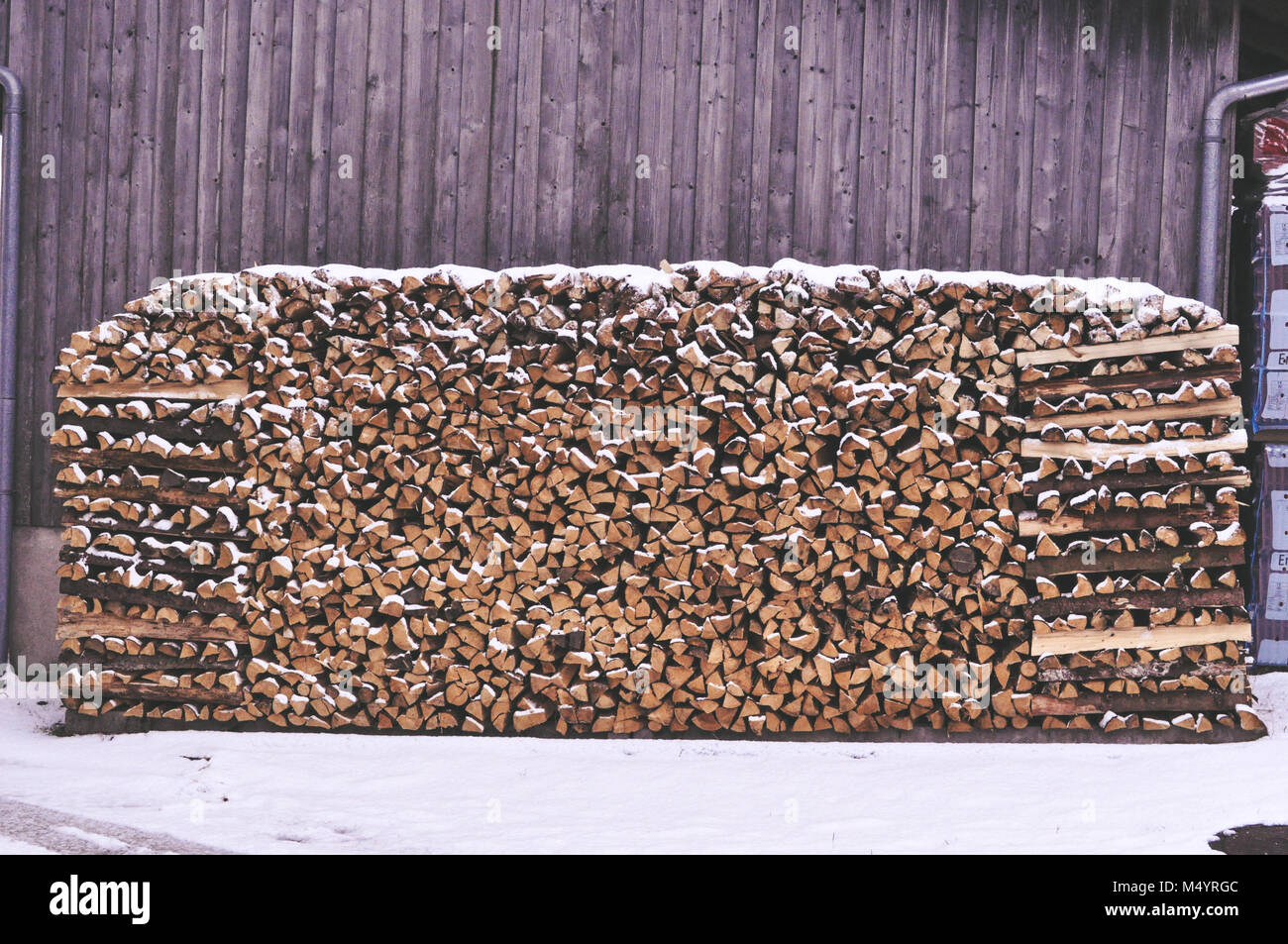 Firewood Stack Background in Winter Stock Photo - Alamy