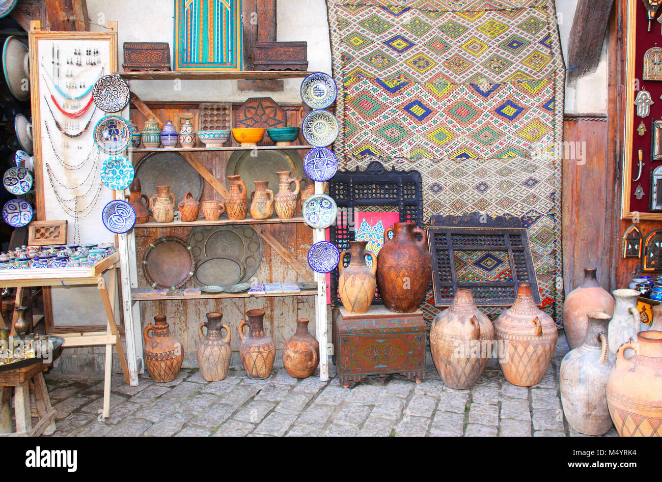 Traditional moroccan souvenirs - carpet, plates, jugs and pots made of ...