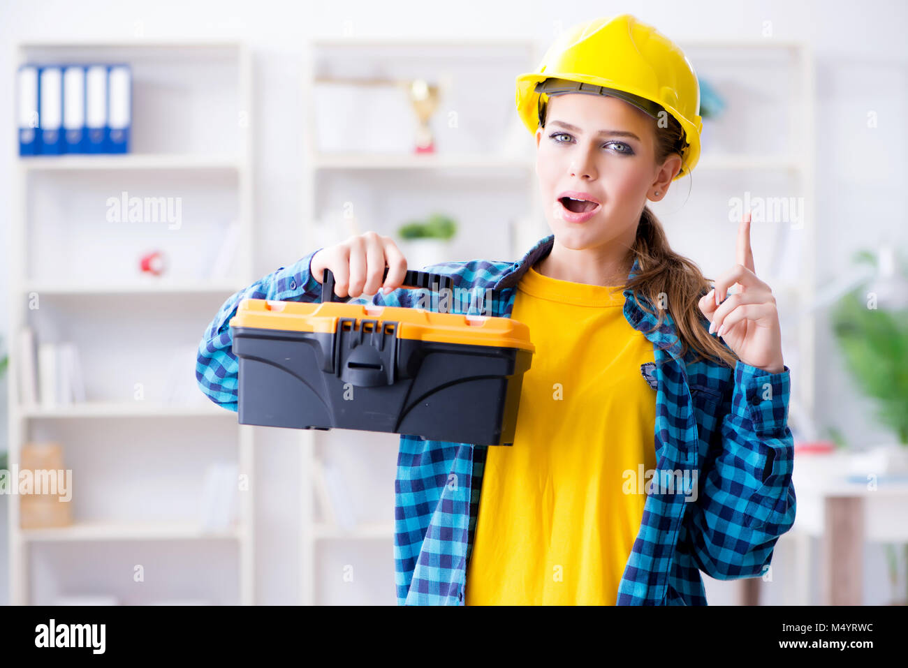 Woman with toolkit in workshop Stock Photo - Alamy