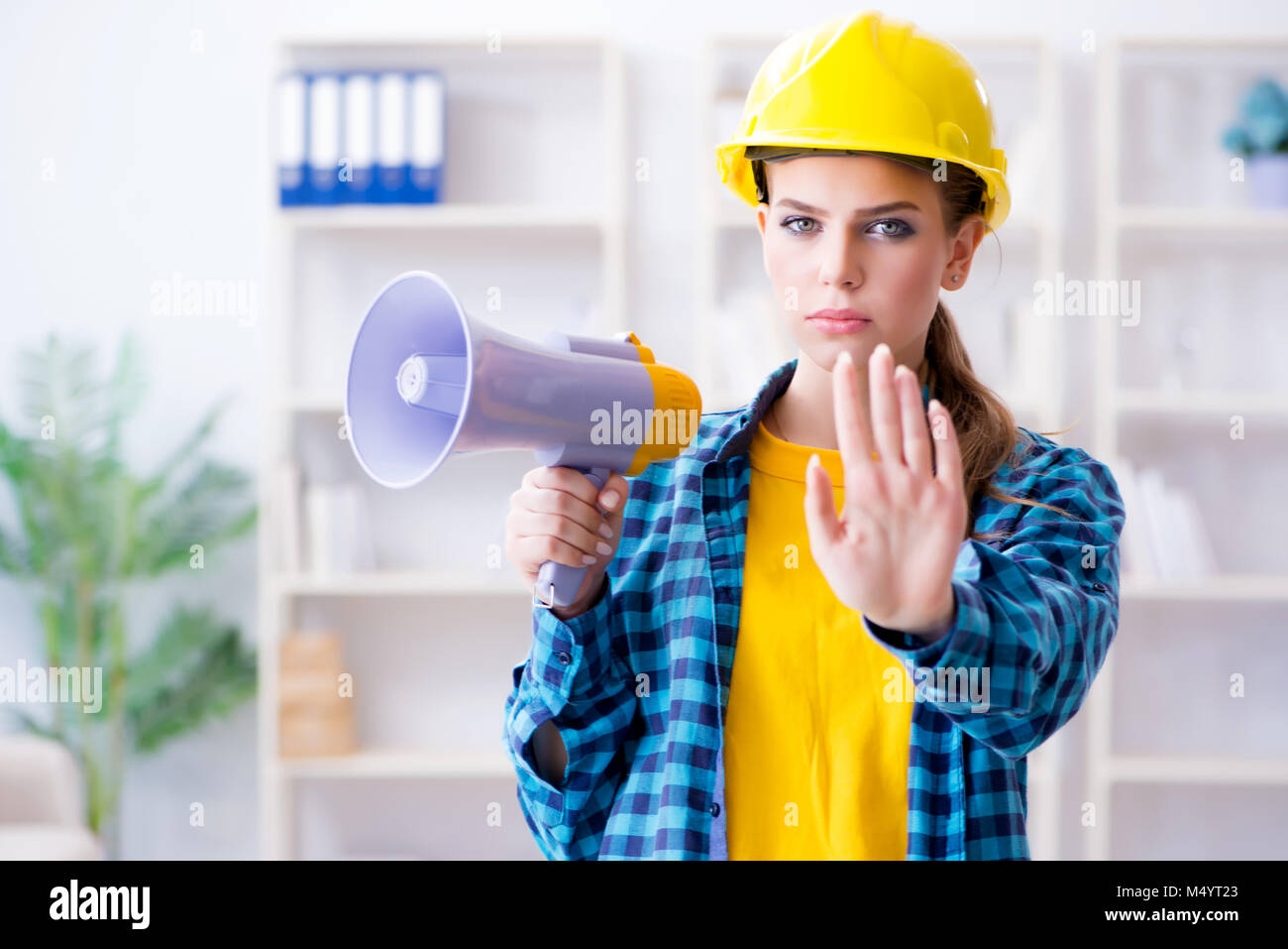 Angry building supervisor with megaphone Stock Photo - Alamy