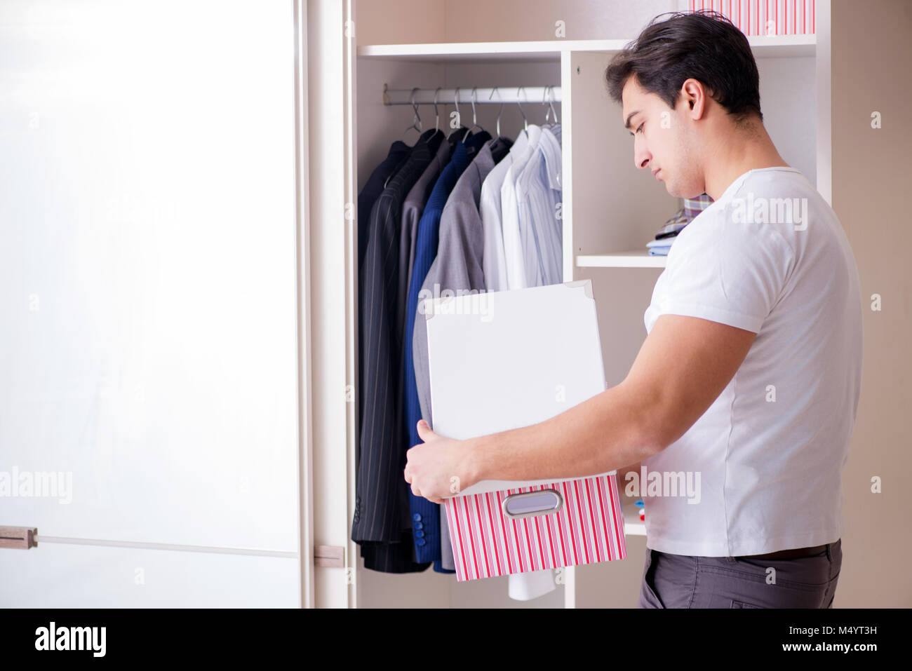 Young man businessman getting dressed for work Stock Photo - Alamy