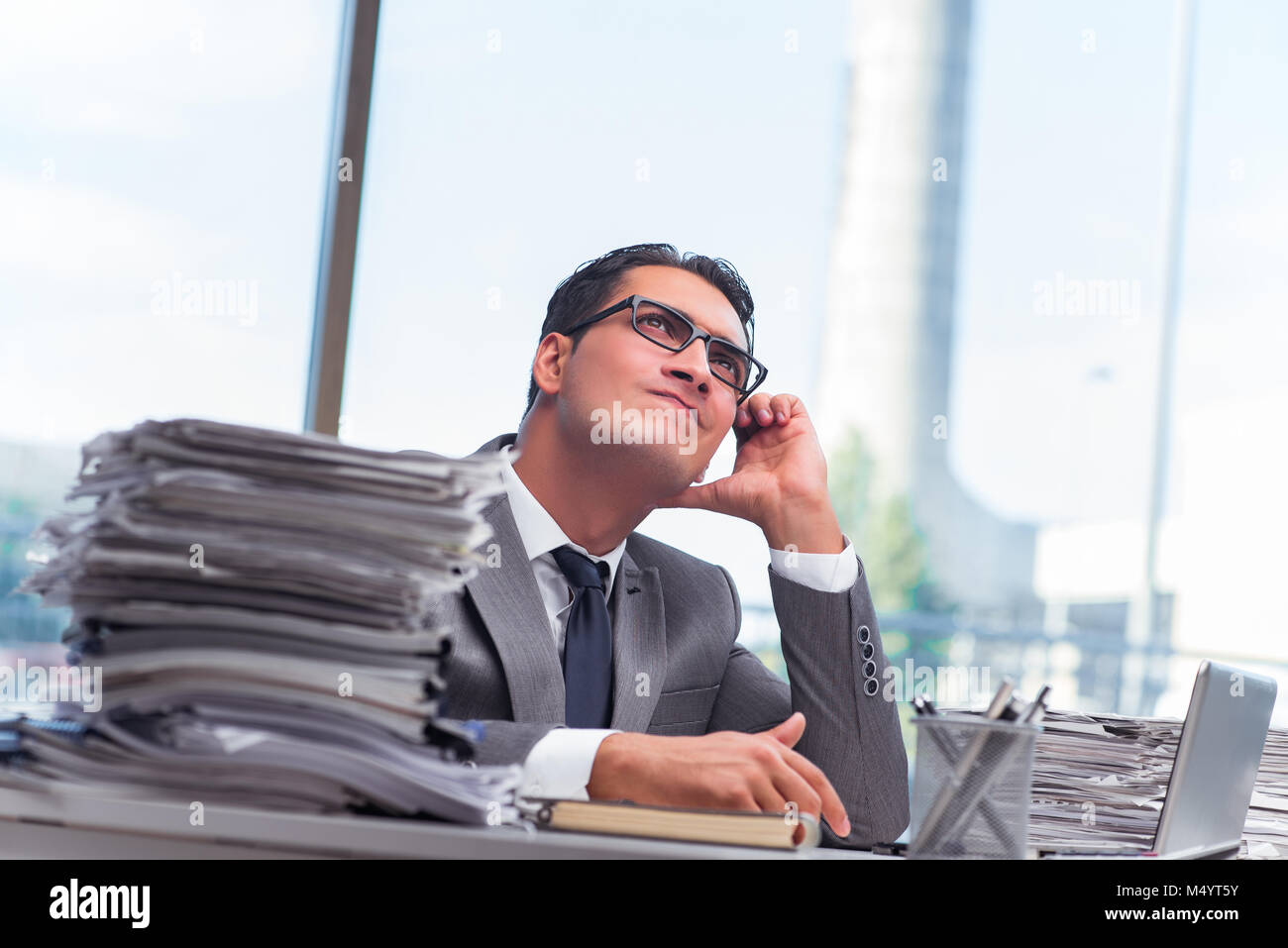 Busy angry businessman with heaps of paper Stock Photo - Alamy