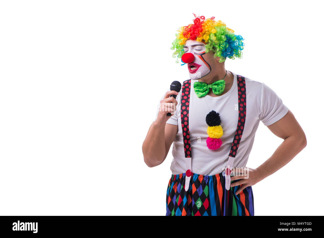 Funny clown with a microphone singing karaoke isolated on white Stock ...